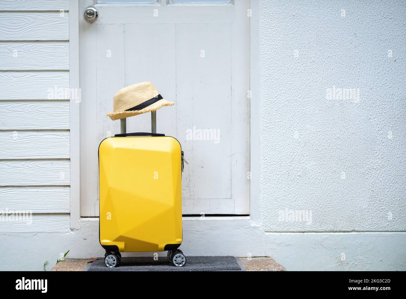 Yellow suitcase, luggage with hat at front door, Leaving home for a ...