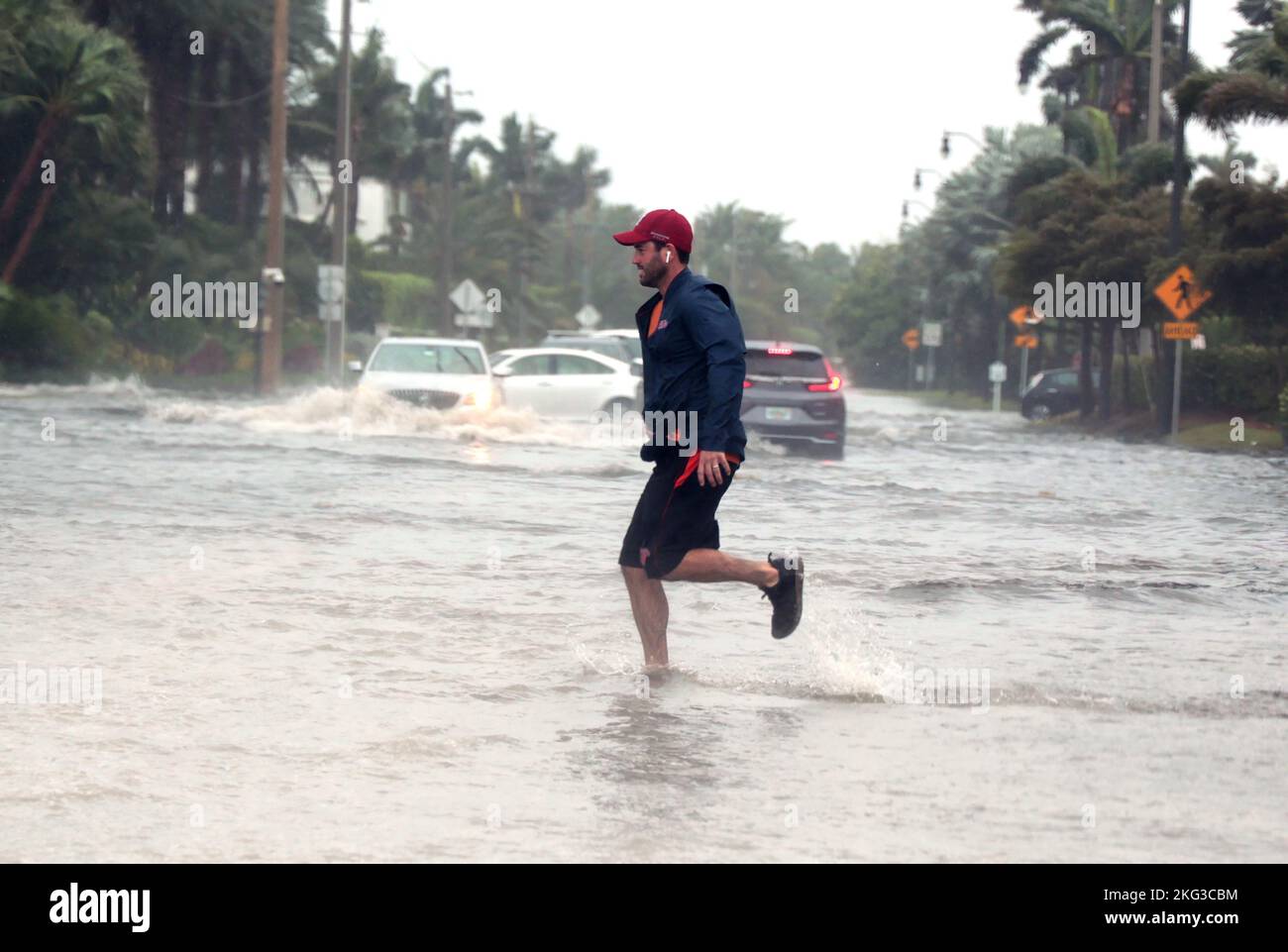 The storm Nicole nears hurricane strength as a man jogs through flooded ...