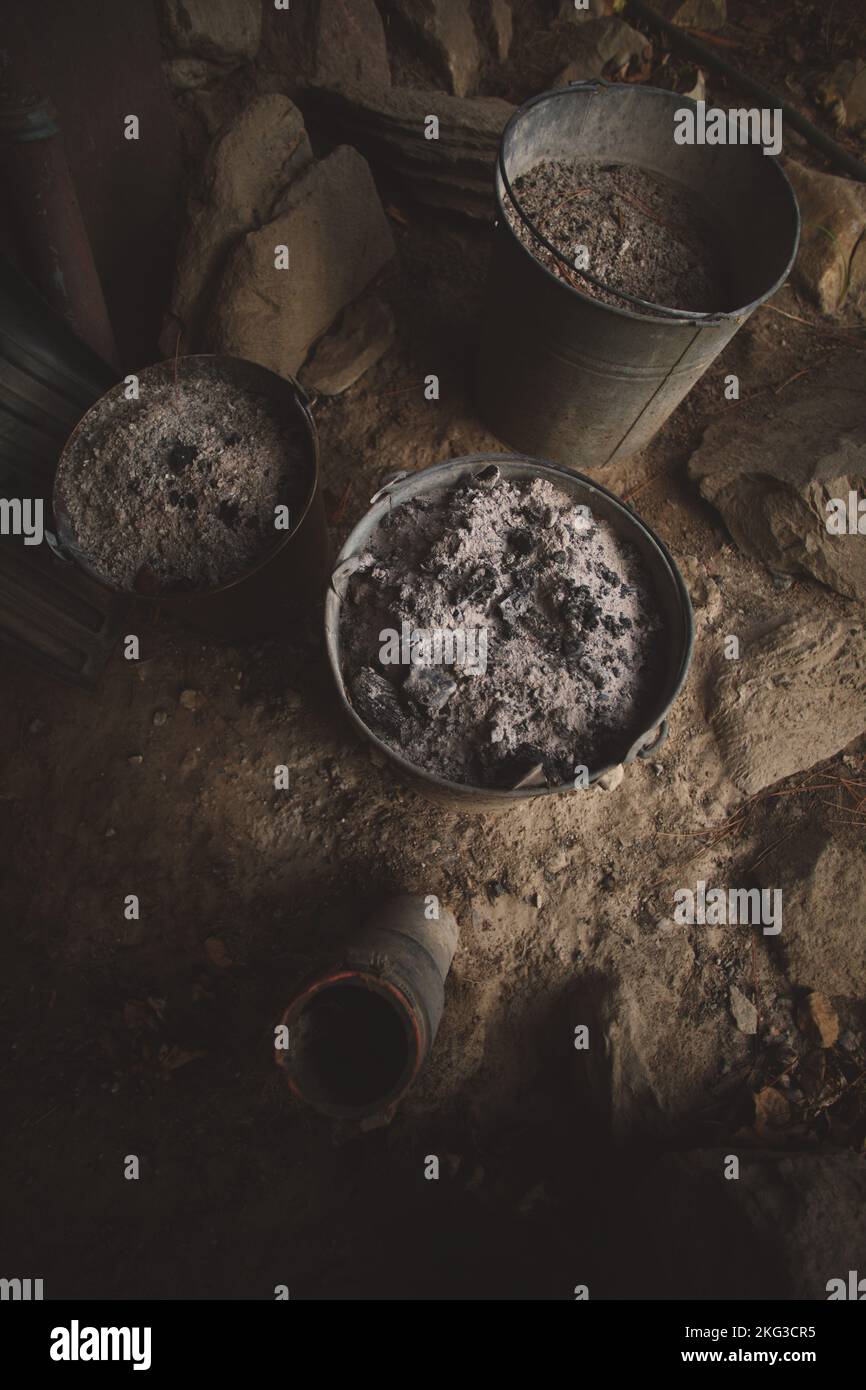A vertical closeup of oven dust in buckets in the pantry with earth ...