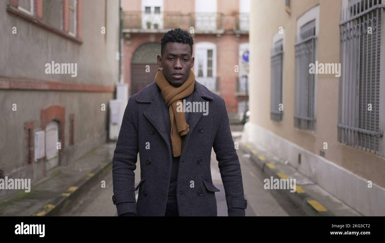 Moody pensive black african man walking in city Stock Photo - Alamy