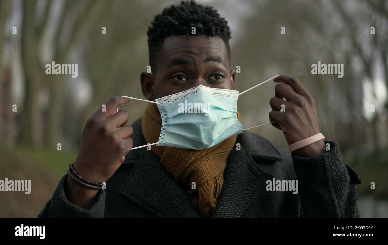 African man removing mask prevention hi-res stock photography and ...