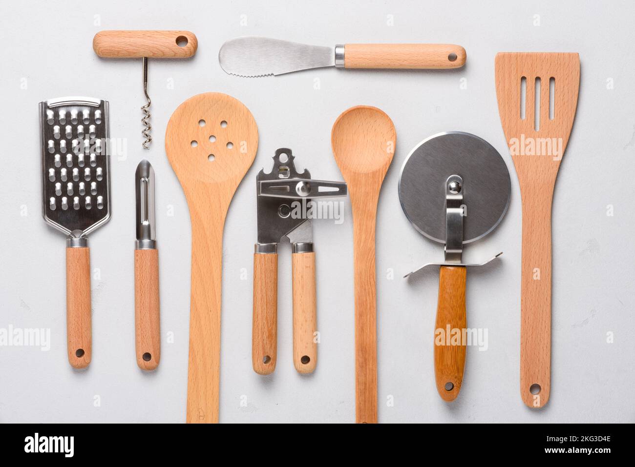 Set of different stainless steel kitchen utensils on concrette stucco ...