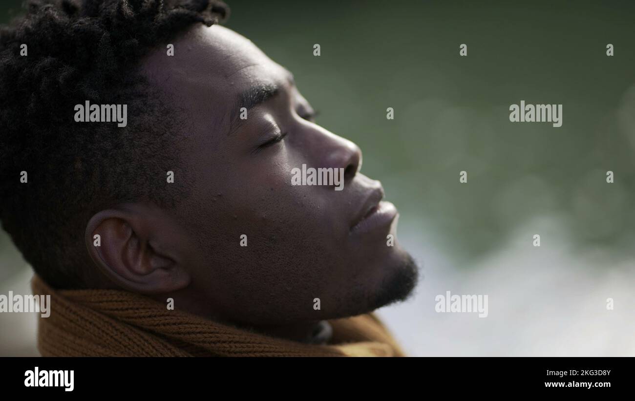 Hopeful young black man head looking up to sky with FAITH Stock Photo ...