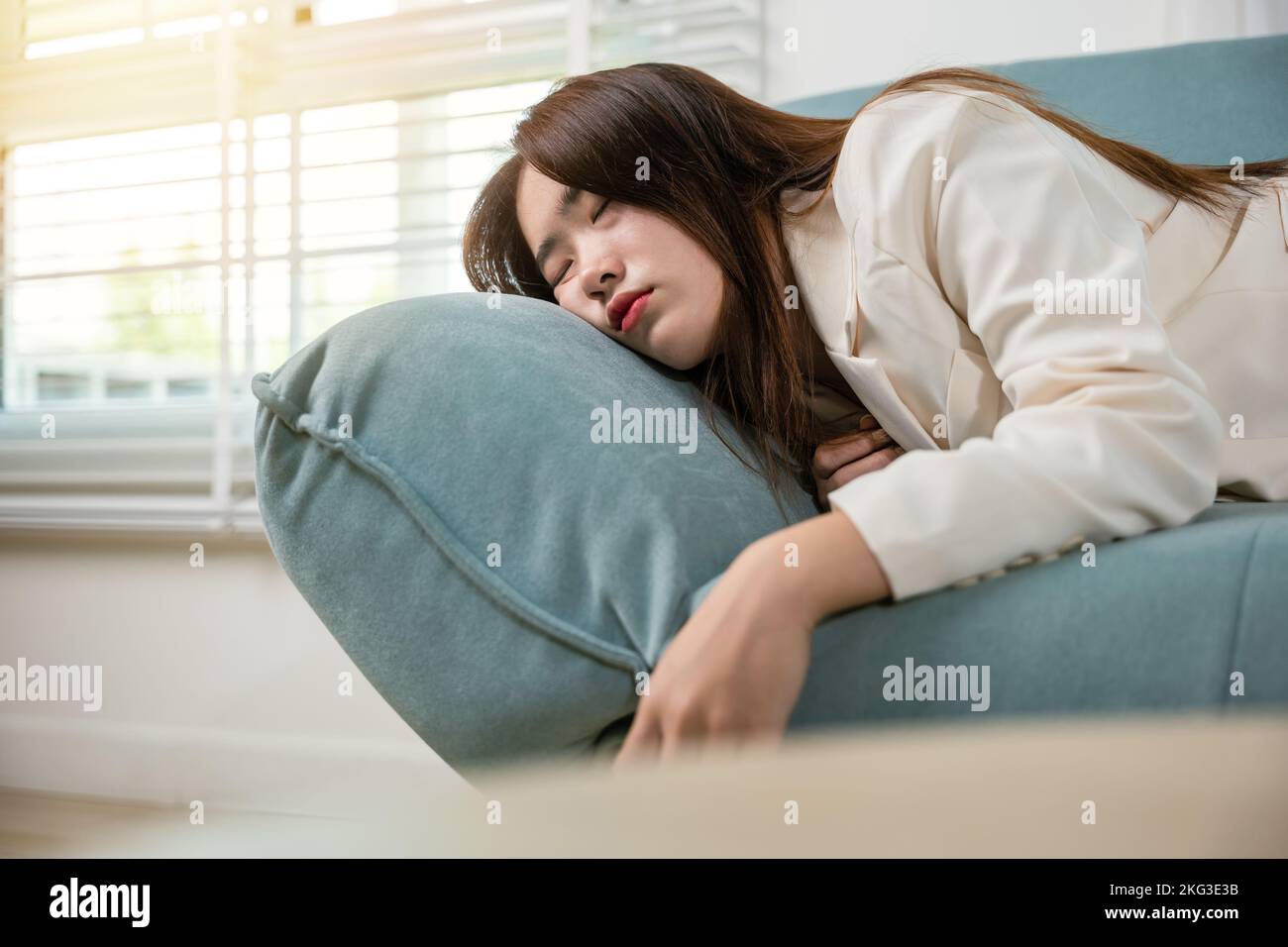 Tired woman sleeping closed eyes on sofa in living room at home Stock ...