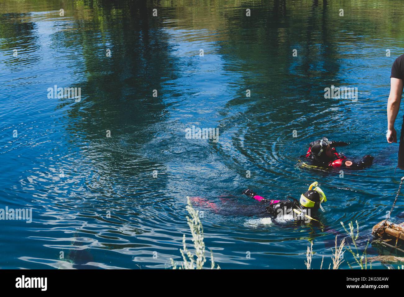 Divers in water. Study of river bottom. Search for missing people ...