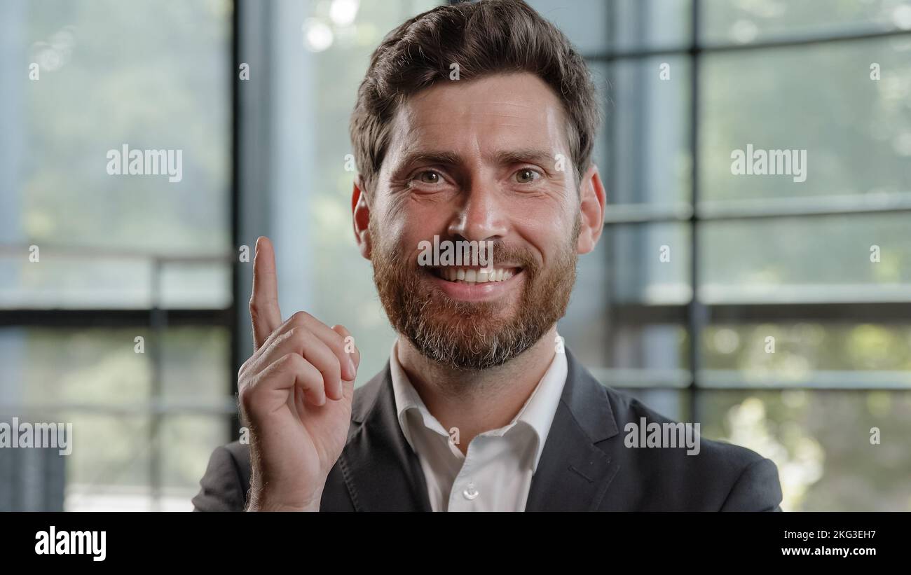 Happy adult Caucasian bearded man 40s businessman posing looks around thinks pondering pensive ...