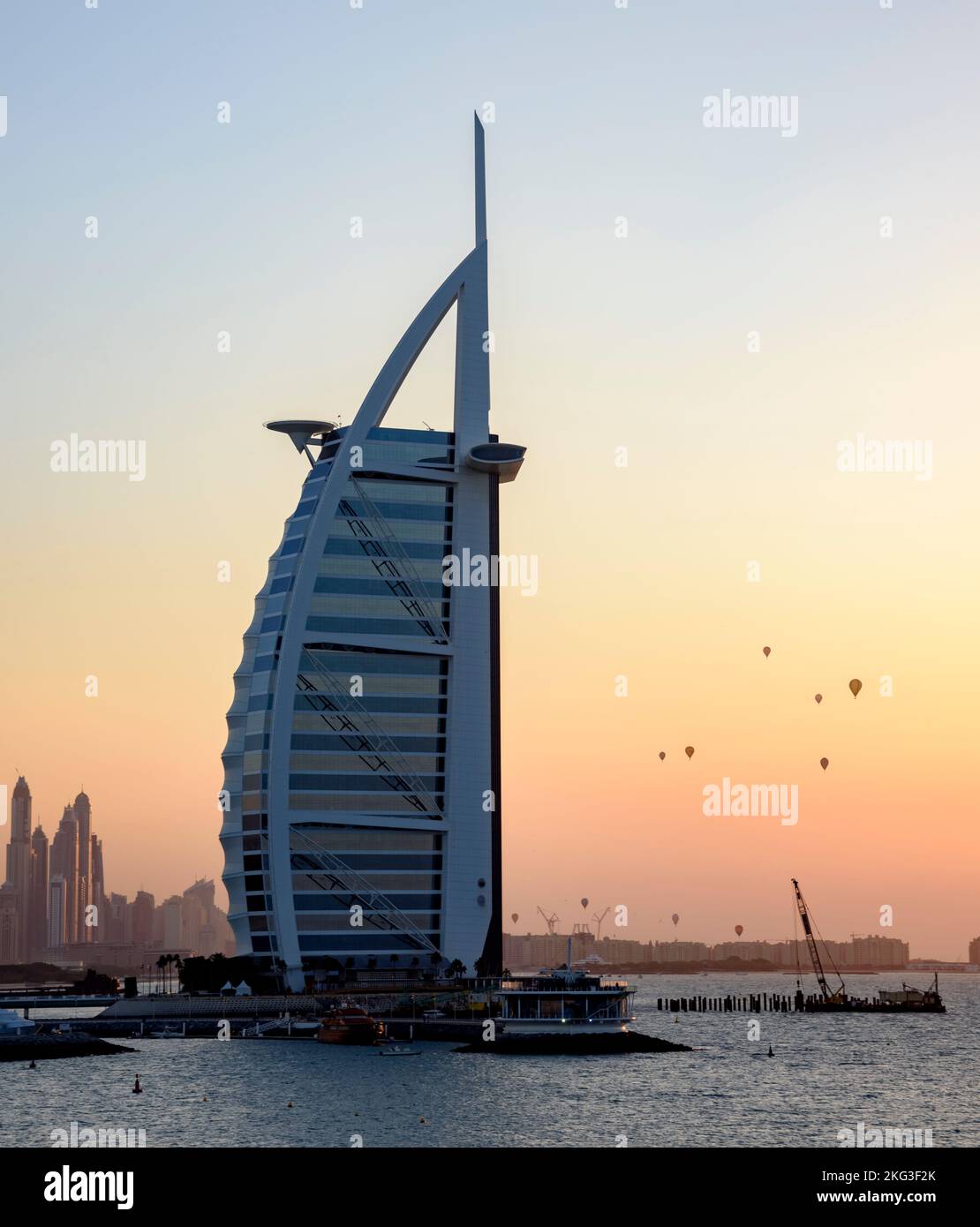 The iconic Burj Al Arab Hotel with Hot air Balloons passing behind it ...