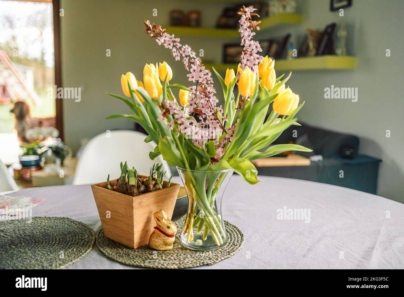 Glass vase with bouquet of beautiful flowers on table in room. Space ...