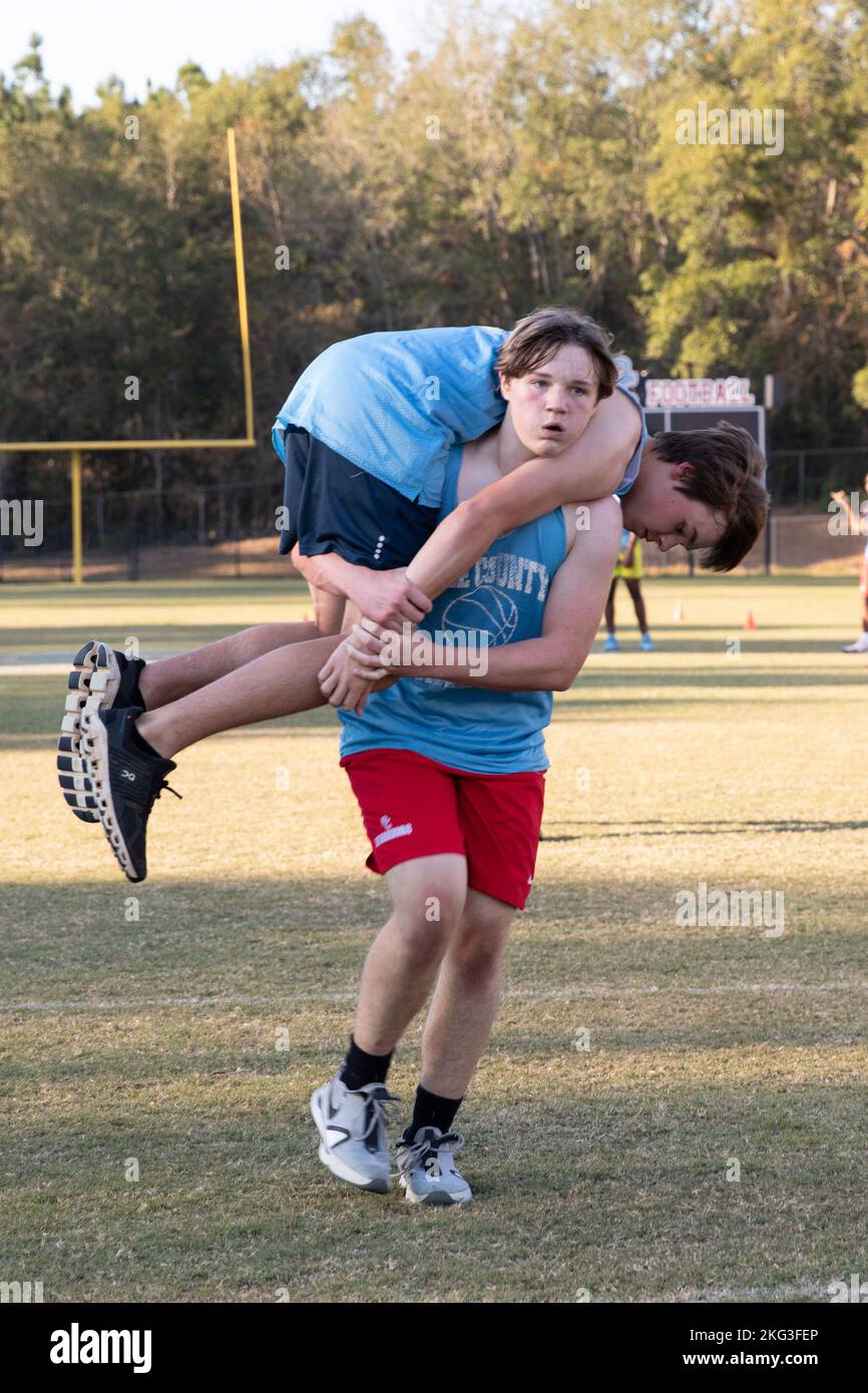 A student from the Dale County High School basketball team carries his ...
