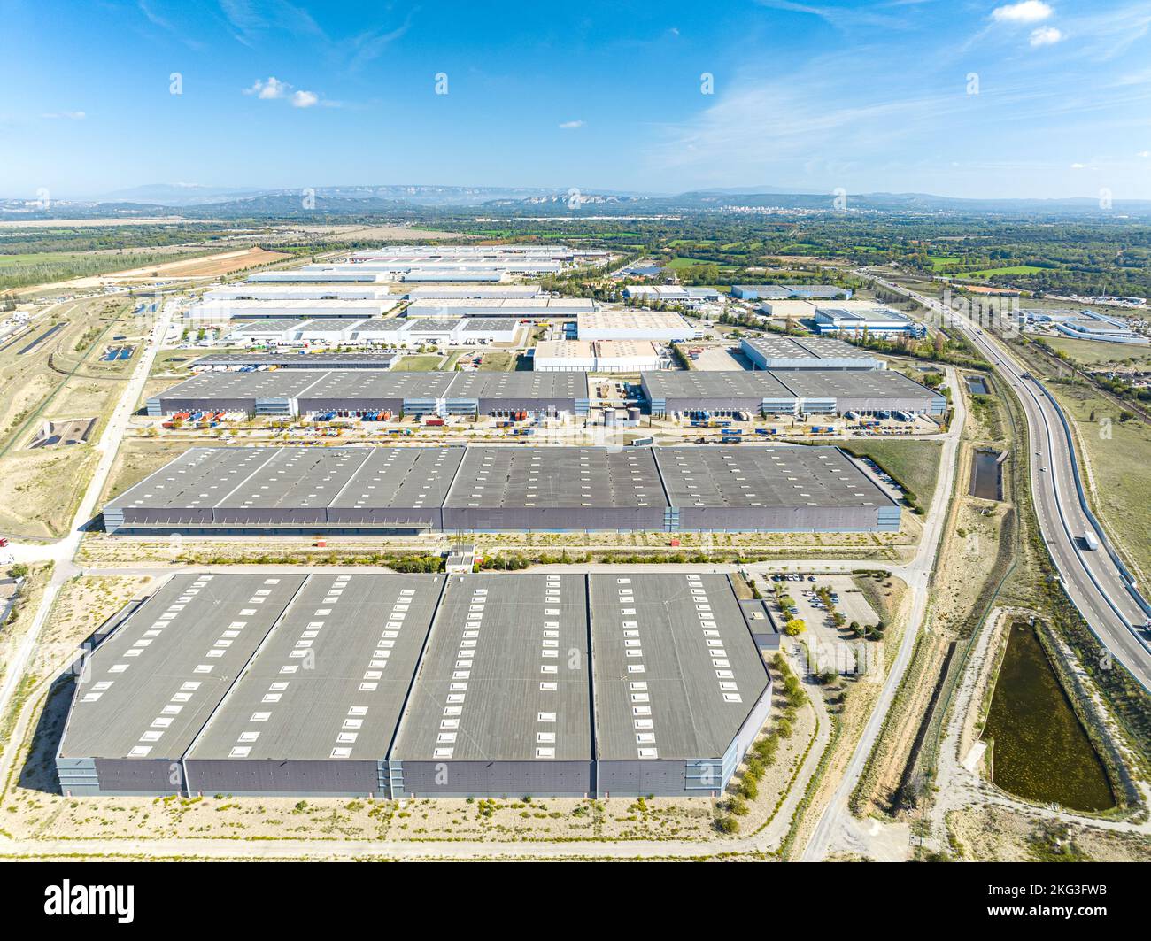 Drone shot of production warehouse near national highway across newly ...