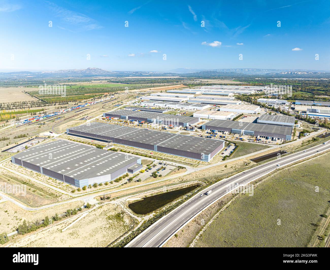 Drone shot of industrial zone featuring national freeway and lush ...