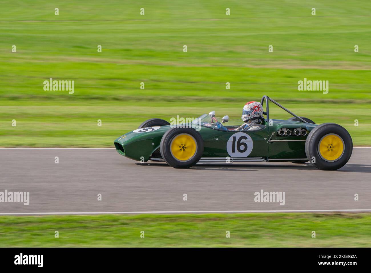 A green Lotus Climax 18 racing round Goodwood Motor Circuit during the ...
