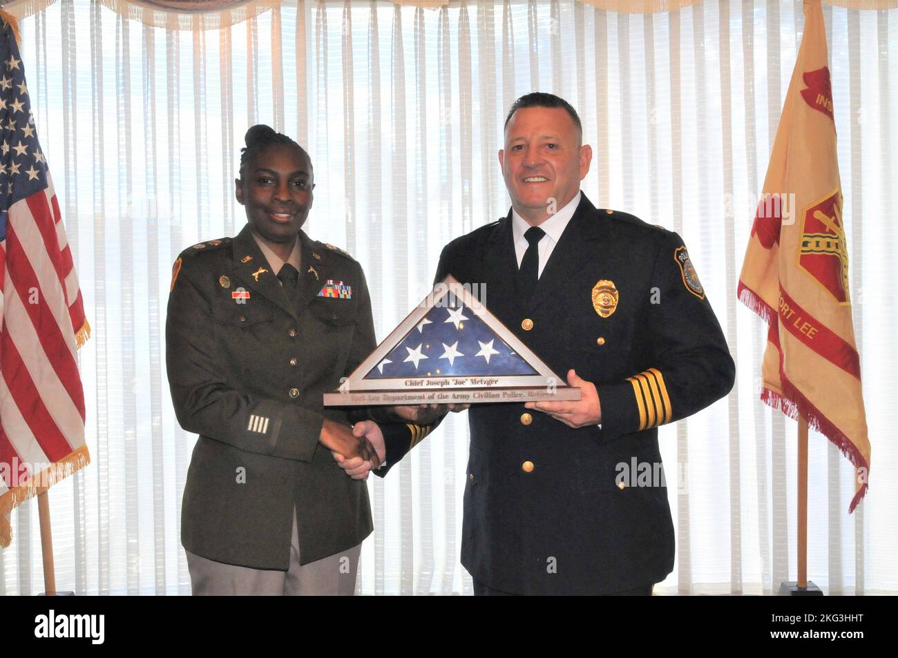 Retiring Chief of Police Joseph C. Metzger, receives an American Flag ...