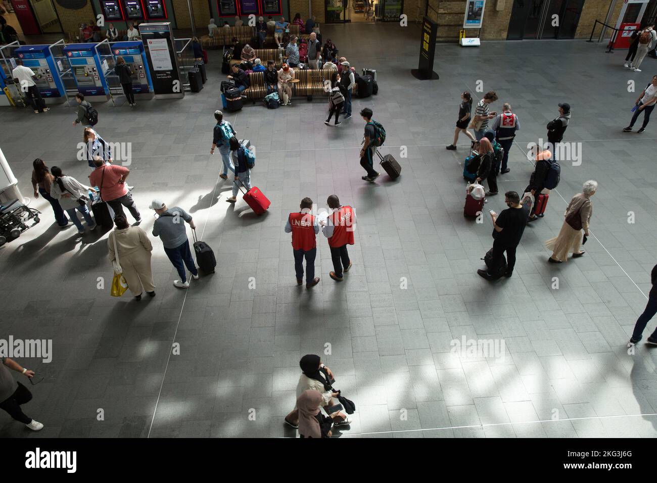 Staff members are seen behind a Union flag bunting as passengers walk ...