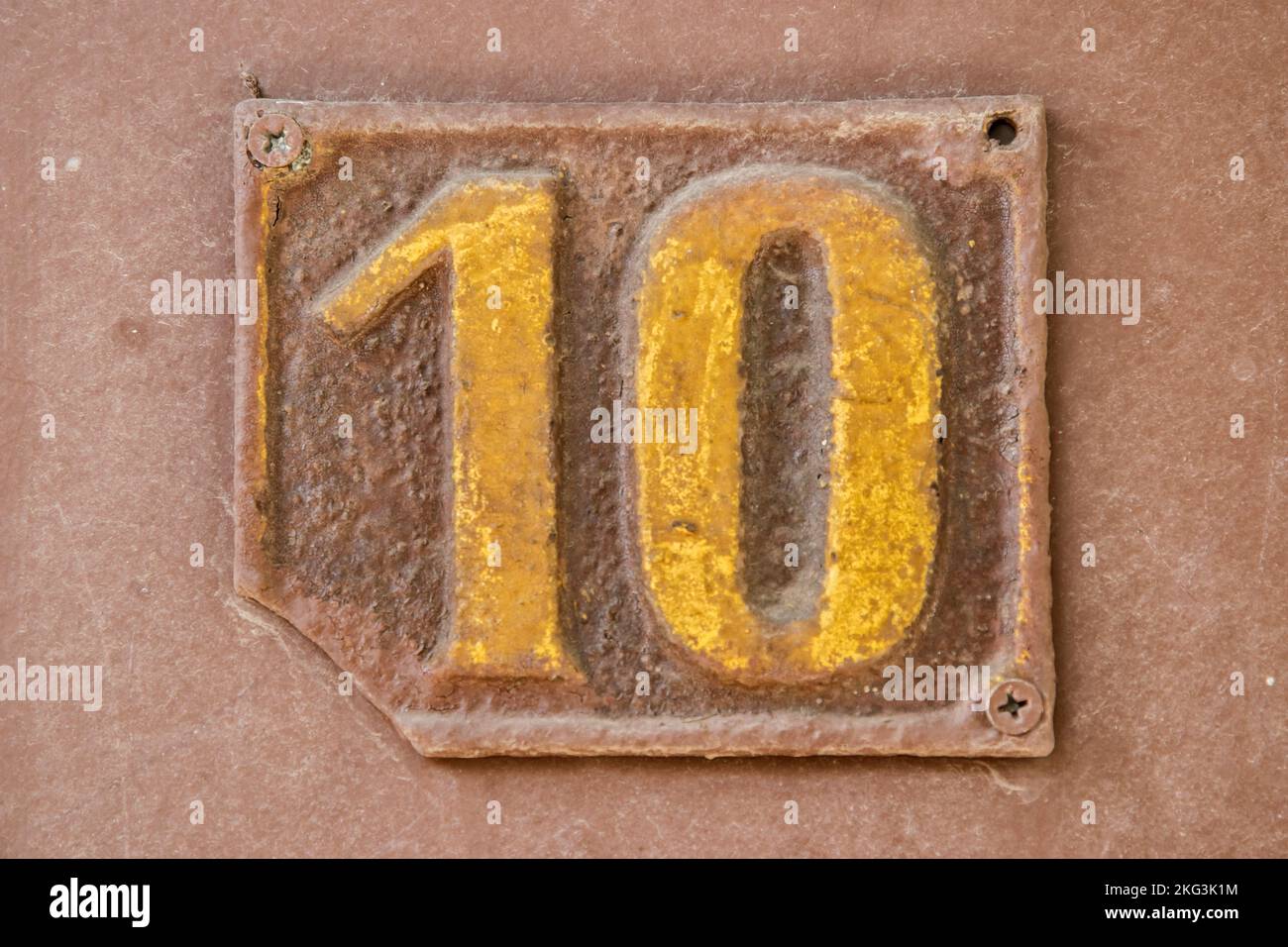 Old retro weathered cast iron plate number 10 closeup Stock Photo - Alamy