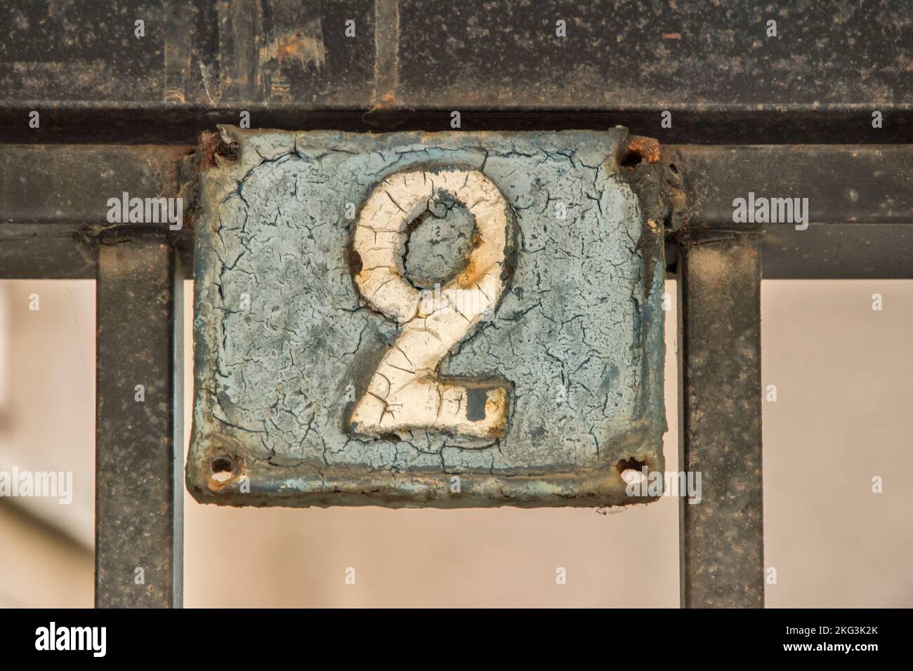 Old retro weathered cast iron plate number 2 closeup Stock Photo - Alamy
