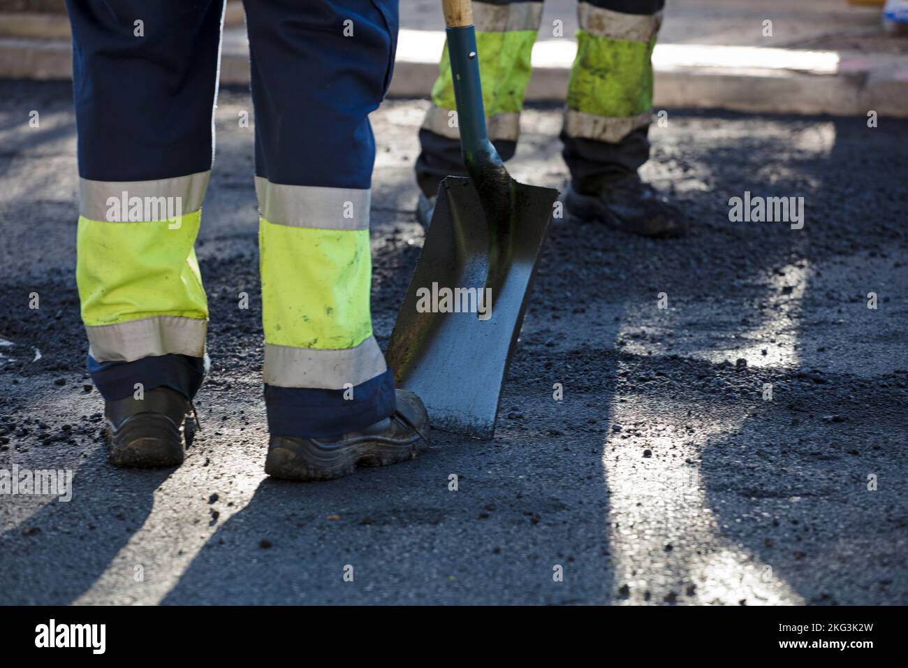 Partial view of uniform asphalt and paving road construction workers ...