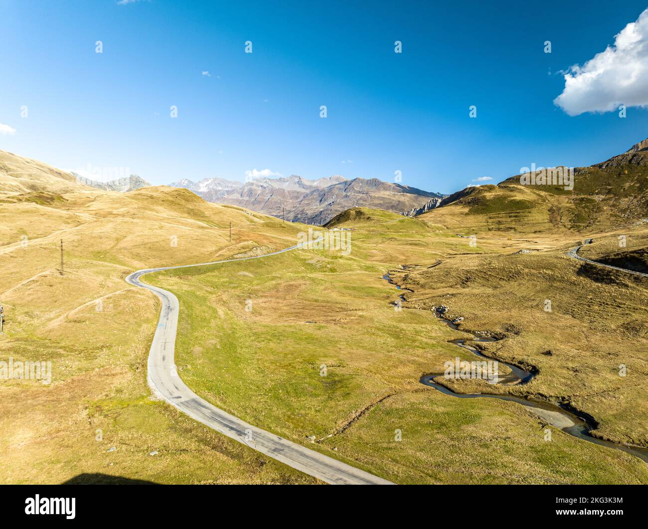 Drone shot of meadow enclosed grassland and distant small hills in the ...