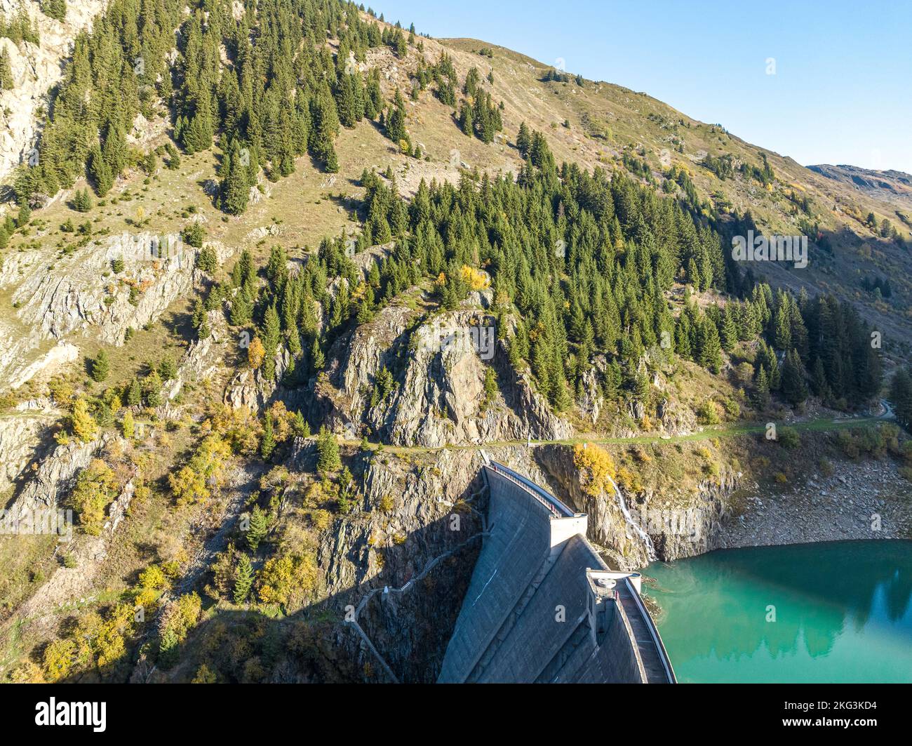 aerial perspective shot of hydroelectric dam on Gittaz lake in alps of ...