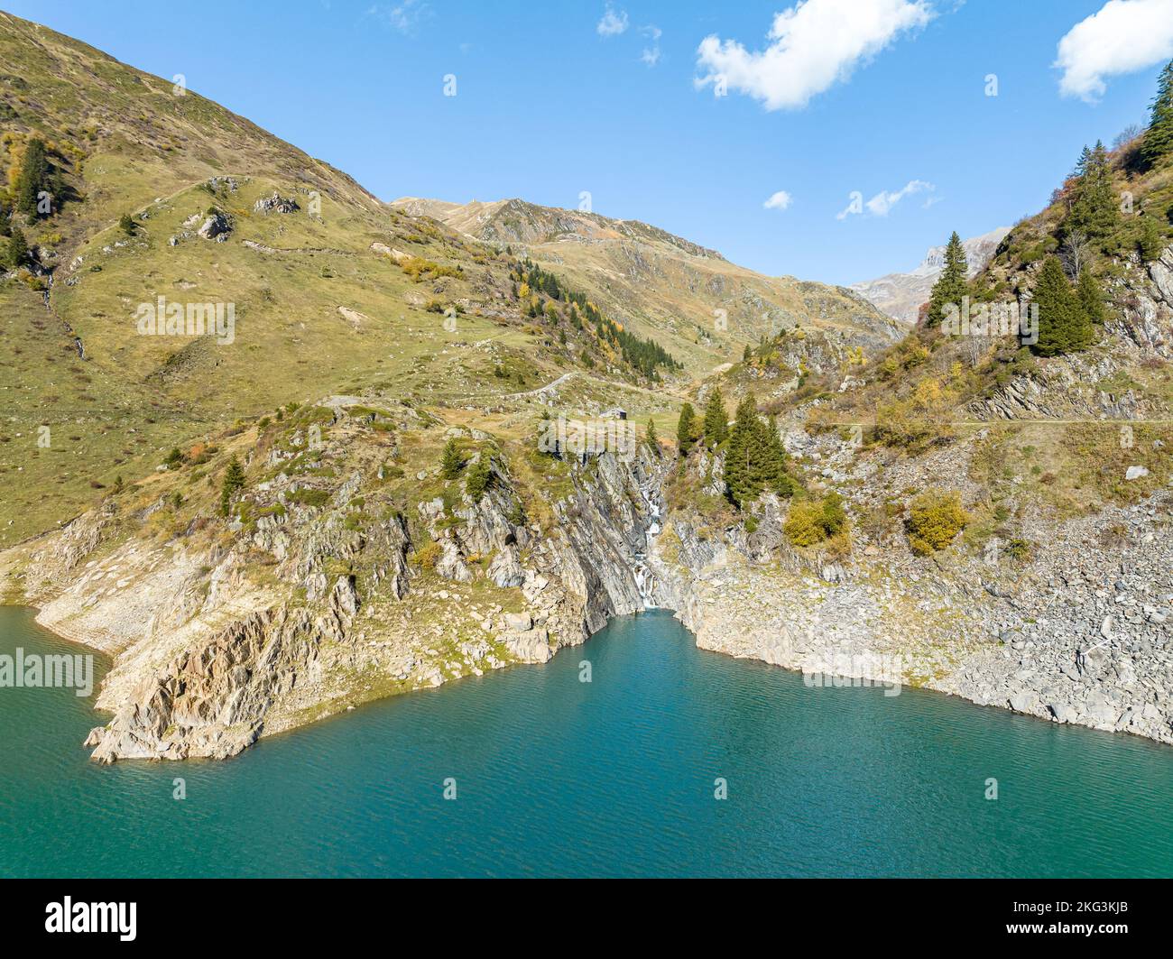 Aerial view of Beaufortain lake in Savoie surrounded by rocky grassland ...