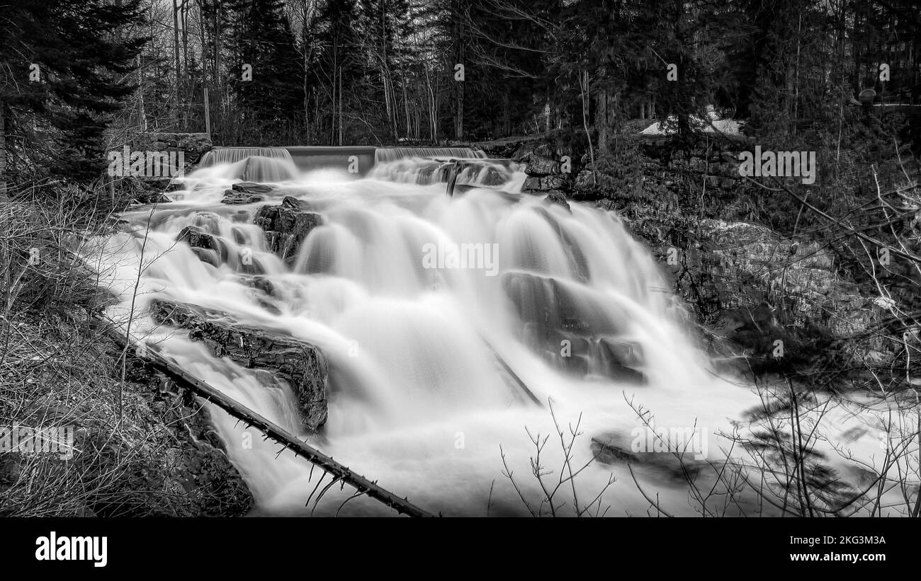 A grayscale long exposure of a scenic waterfall Stock Photo - Alamy