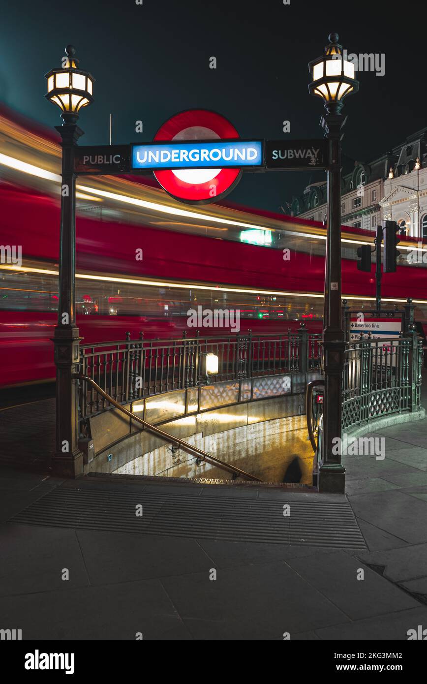 A closeup shot of a underground sign in the middle of street lights in ...