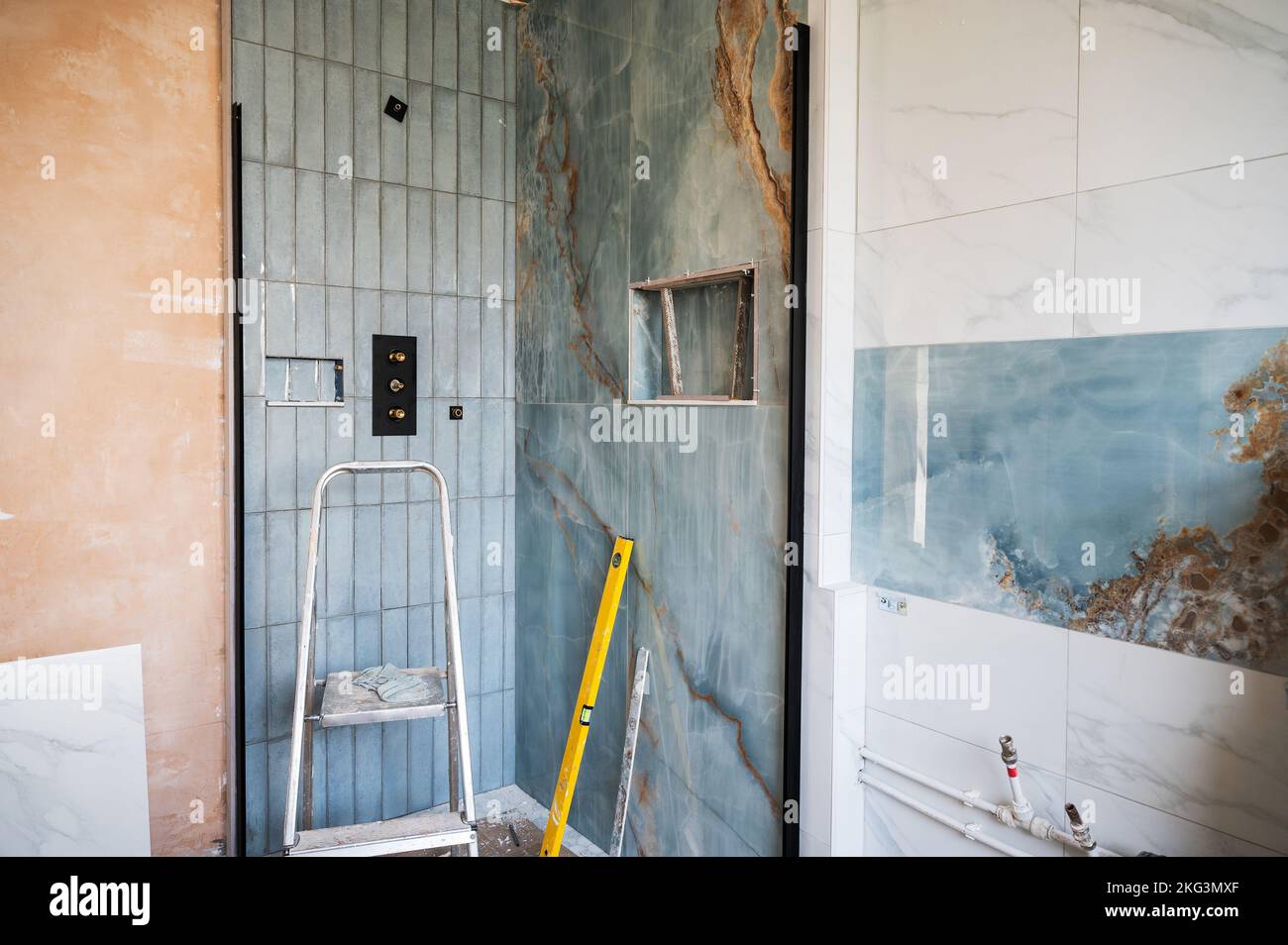 Unfinished diy project of shower room. White and light blue marble ...