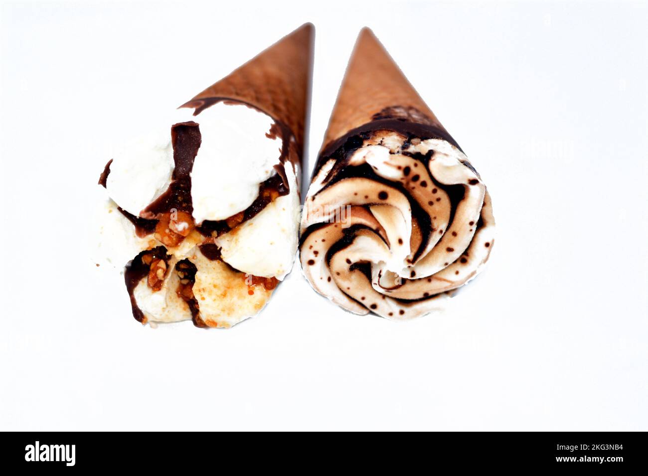 Ice cream vanilla cones with topping of chocolate and caramel sauce and ...