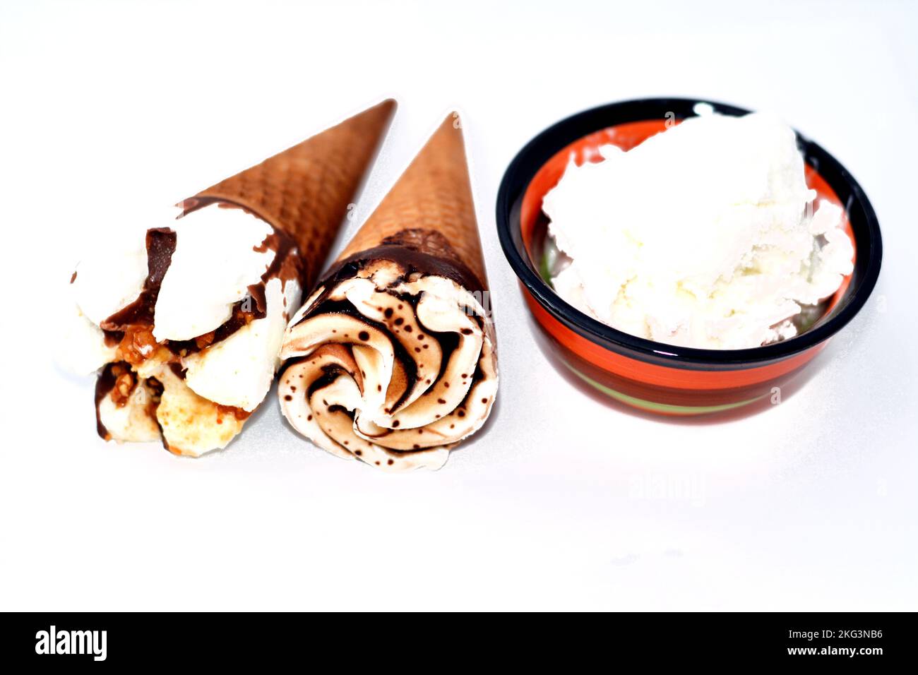 Ice cream vanilla cones with topping of chocolate and caramel sauce and ...