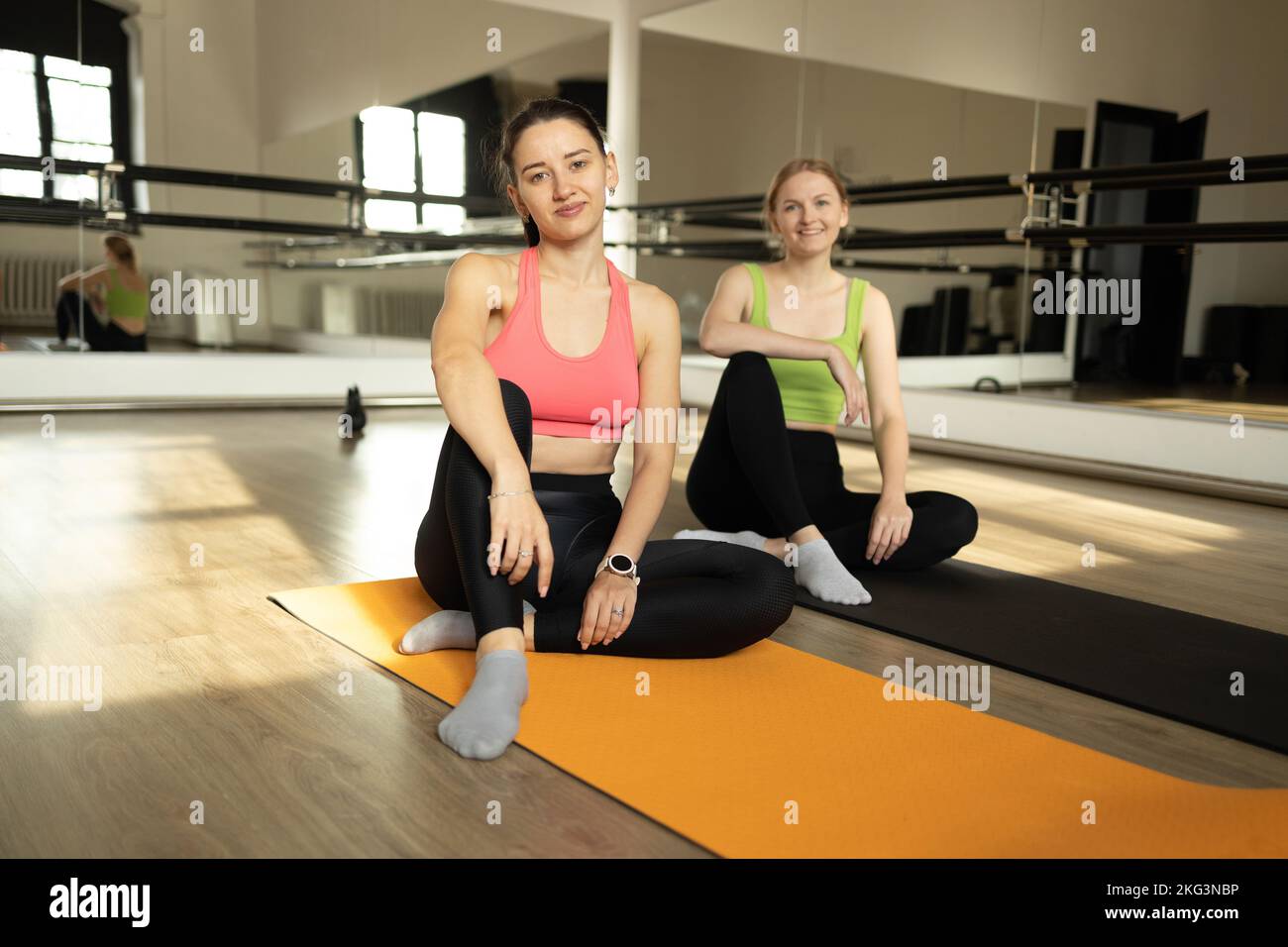 Two beautiful sport woman talking and laugh in the bedroom after ...