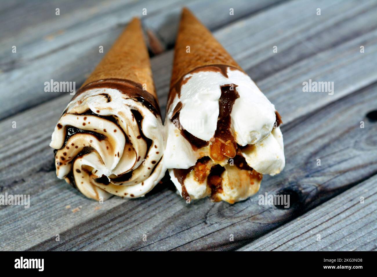 Ice cream vanilla cones with topping of chocolate and caramel sauce and ...
