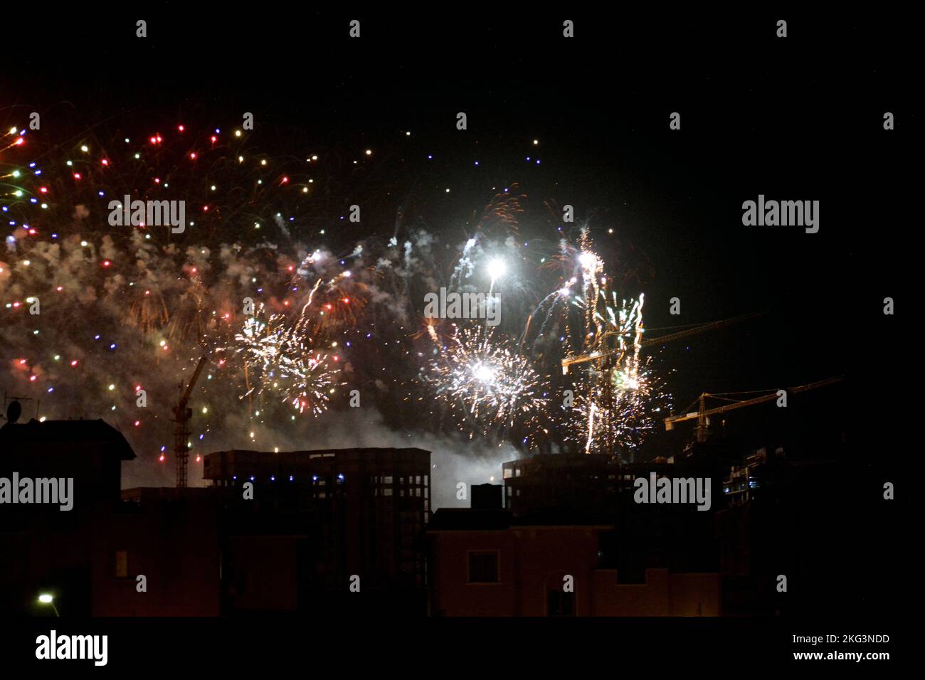 colorful fireworks at night with shadows of a construction site and ...