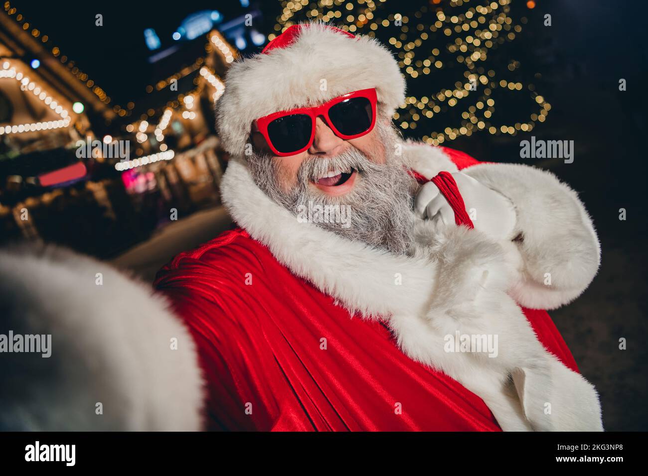 Portrait of excited crazy grandfather santa claus make selfie evening ...