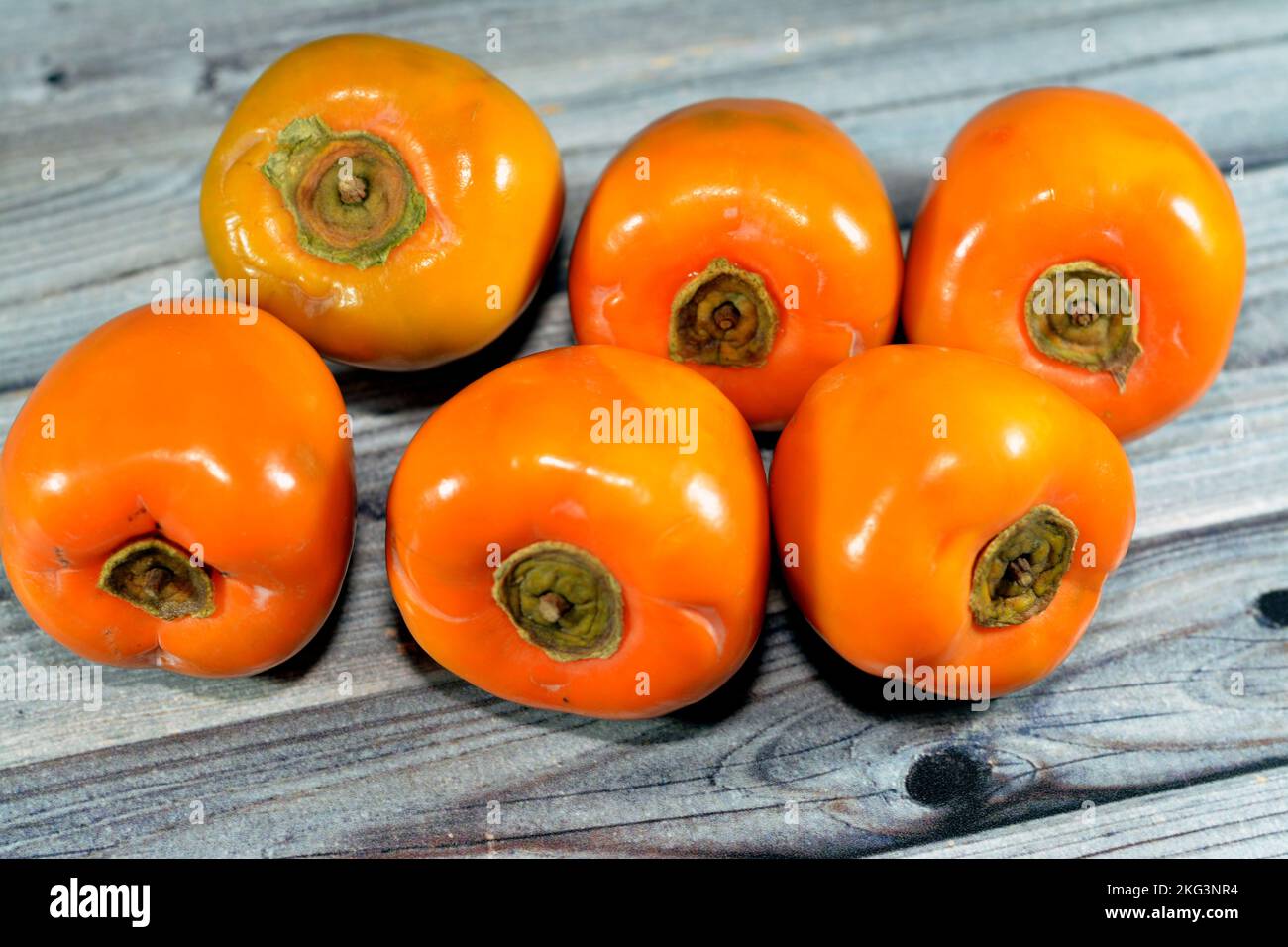 The persimmon is the edible fruit of a number of species of trees in ...