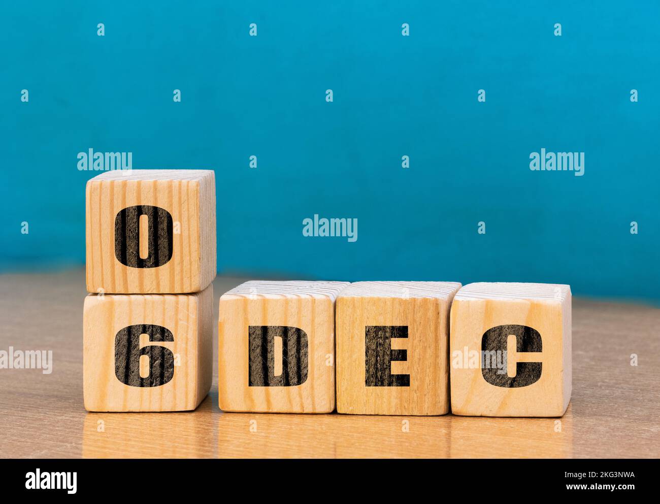 Cube shape calendar for December 06 on wooden surface with empty space ...