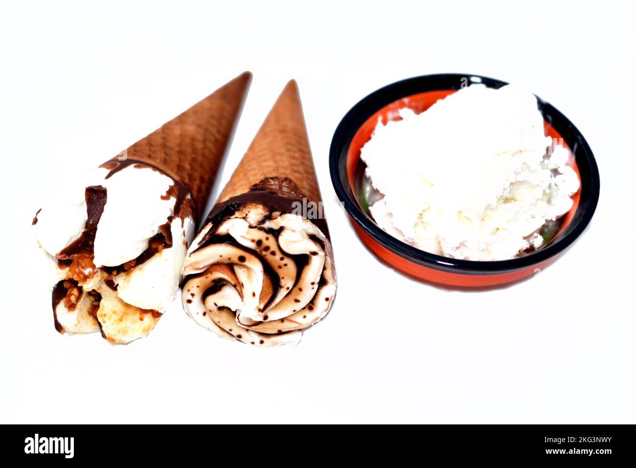 Ice cream vanilla cones with topping of chocolate and caramel sauce and ...
