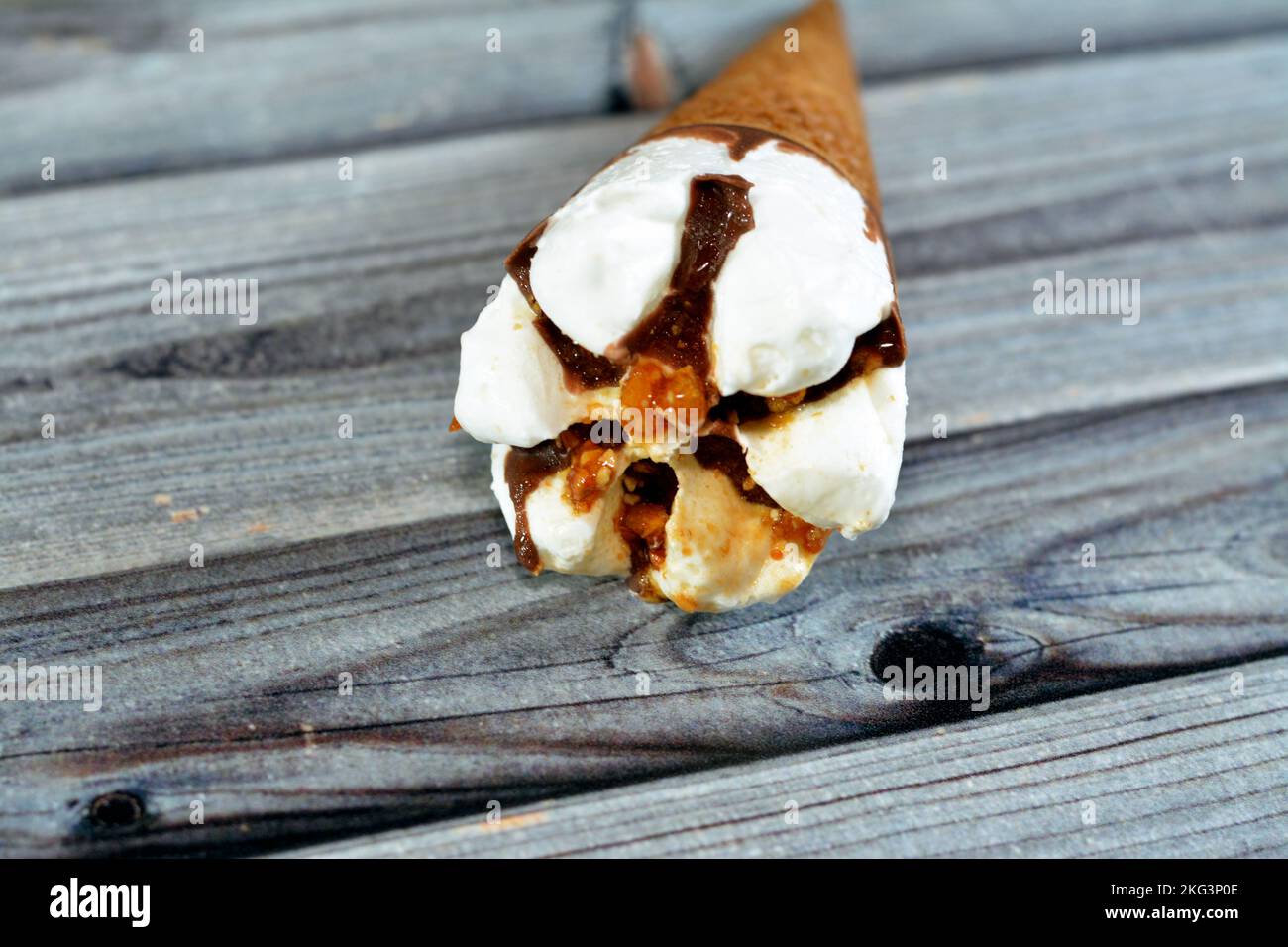 ice cream vanilla scoop cone with topping of chocolate and caramel ...