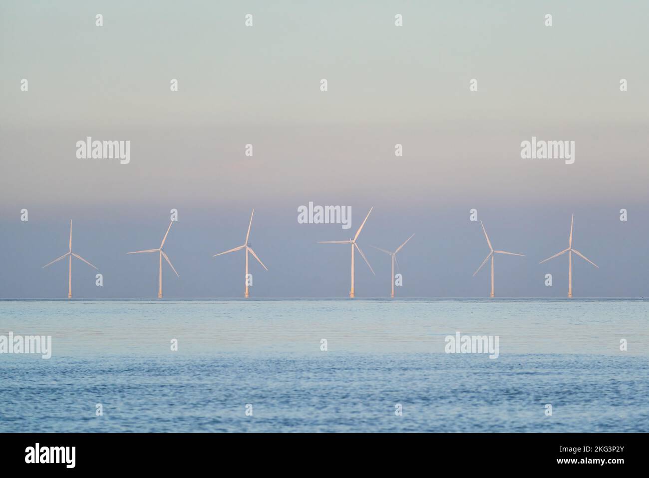 A distant shot of offshore wind energy farm of seven windmills in the ...