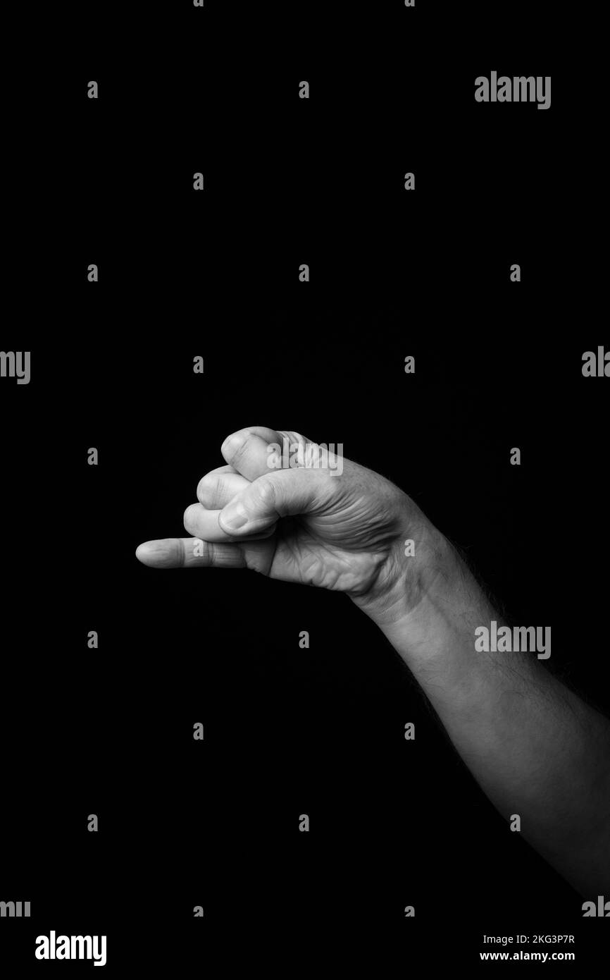 Dramatic black and white image of a male hand fingerspelling the Fench ...