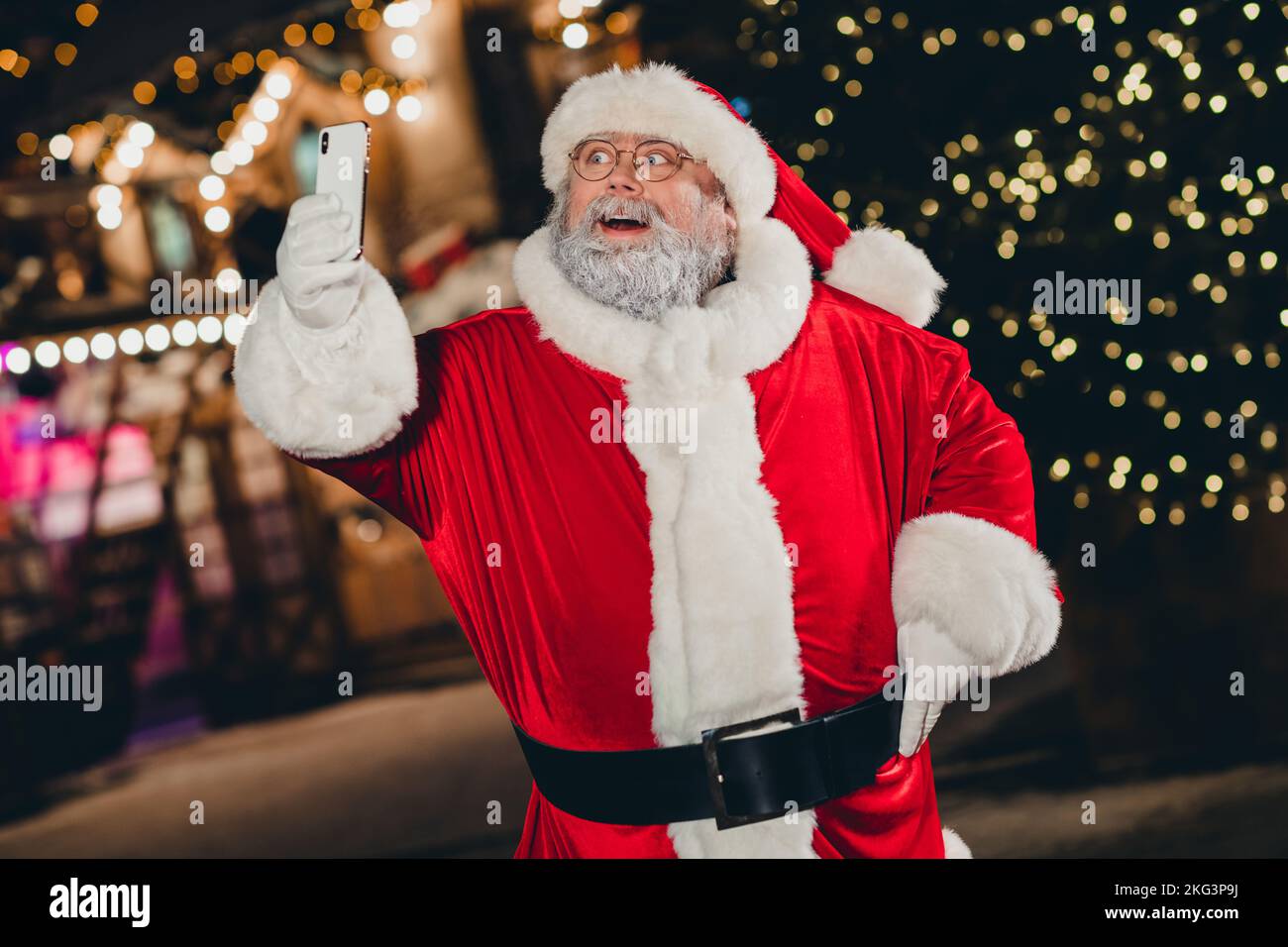 Portrait of funky granddad santa hold telephone make selfie record ...