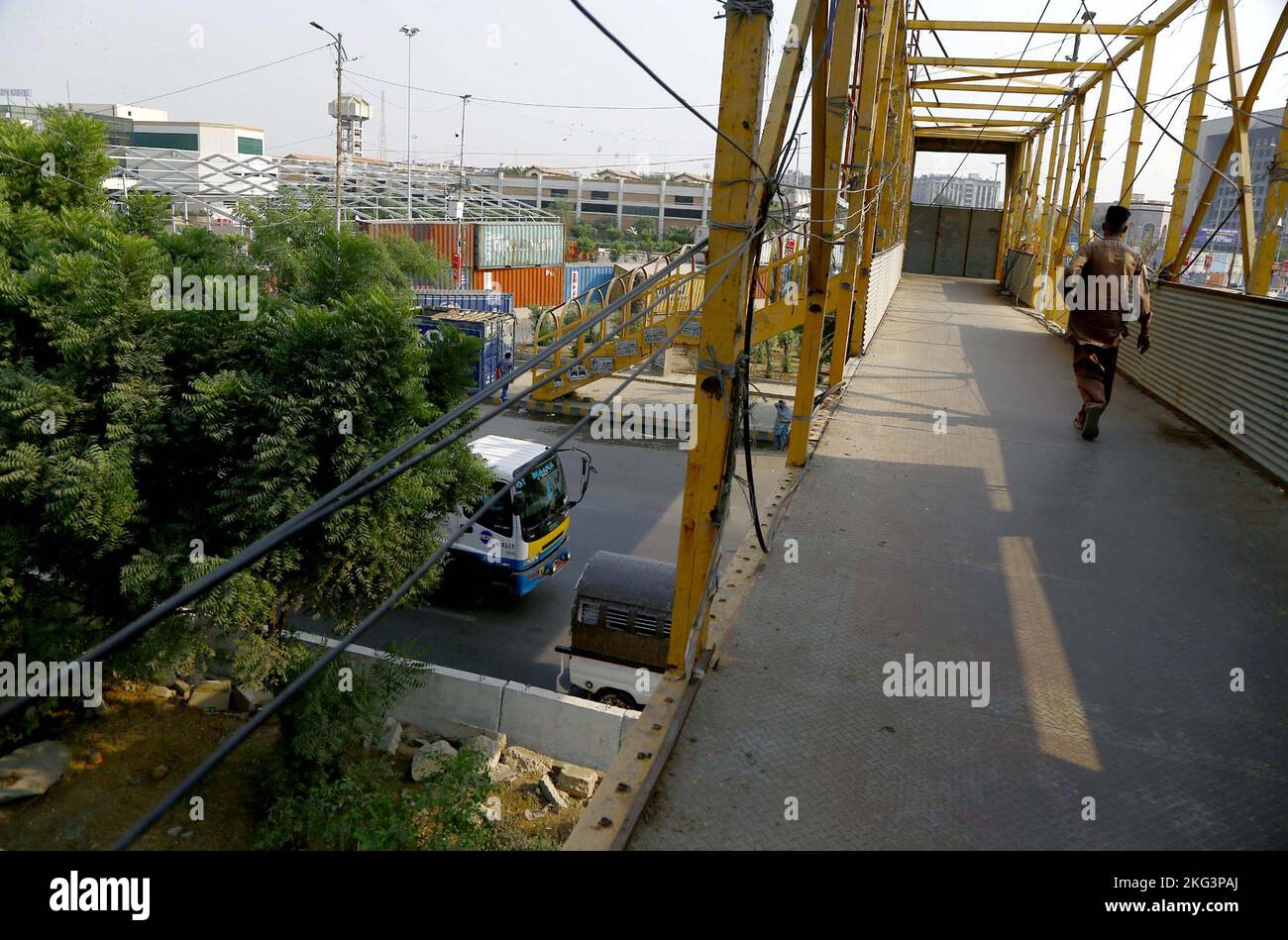 Commuters pass through the damaged pedestrian bridge that may cause any ...