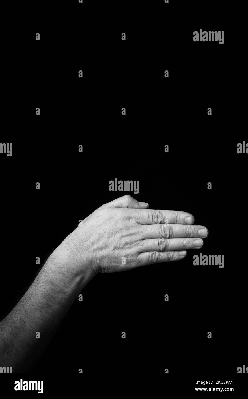 Dramatic black and white image of a male hand fingerspelling the Fench ...