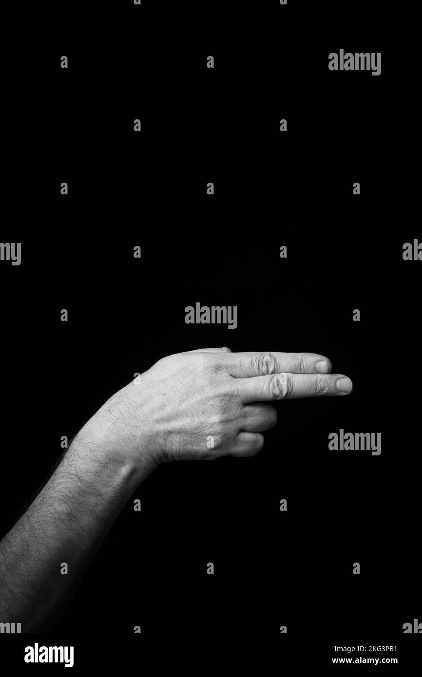 Dramatic black and white image of a male hand fingerspelling the Fench ...