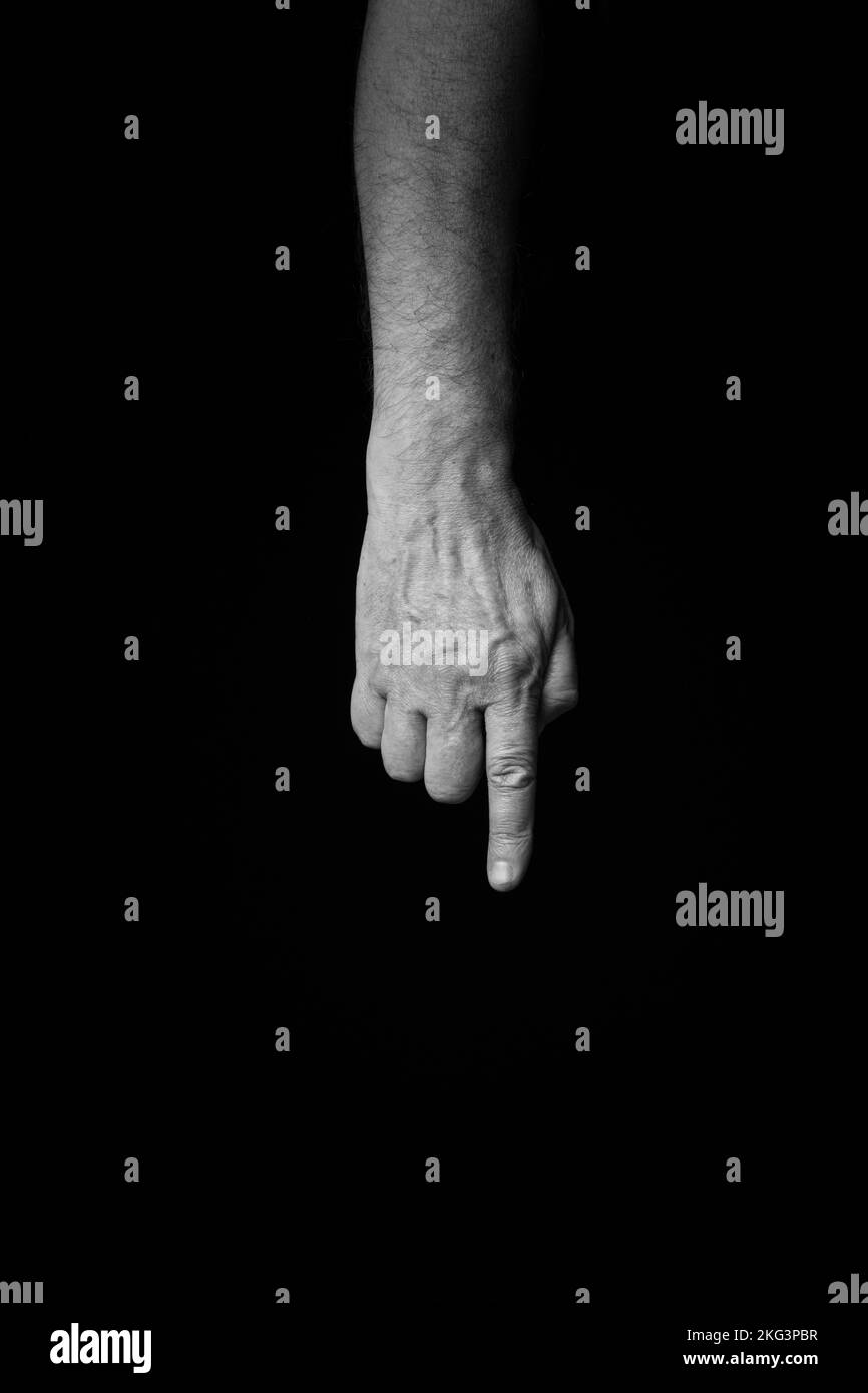 Dramatic black and white image of a male hand fingerspelling the Fench ...