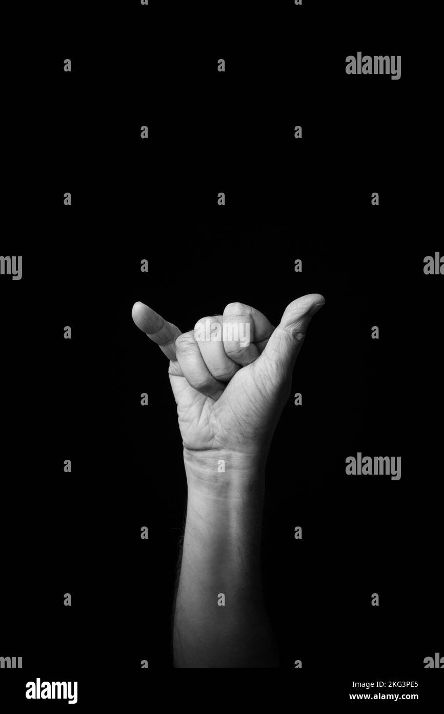 Dramatic black and white image of a male hand fingerspelling the Fench ...