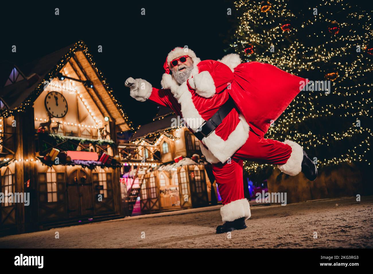 Full size portrait of funky excited grandfather santa hold presents bag ...