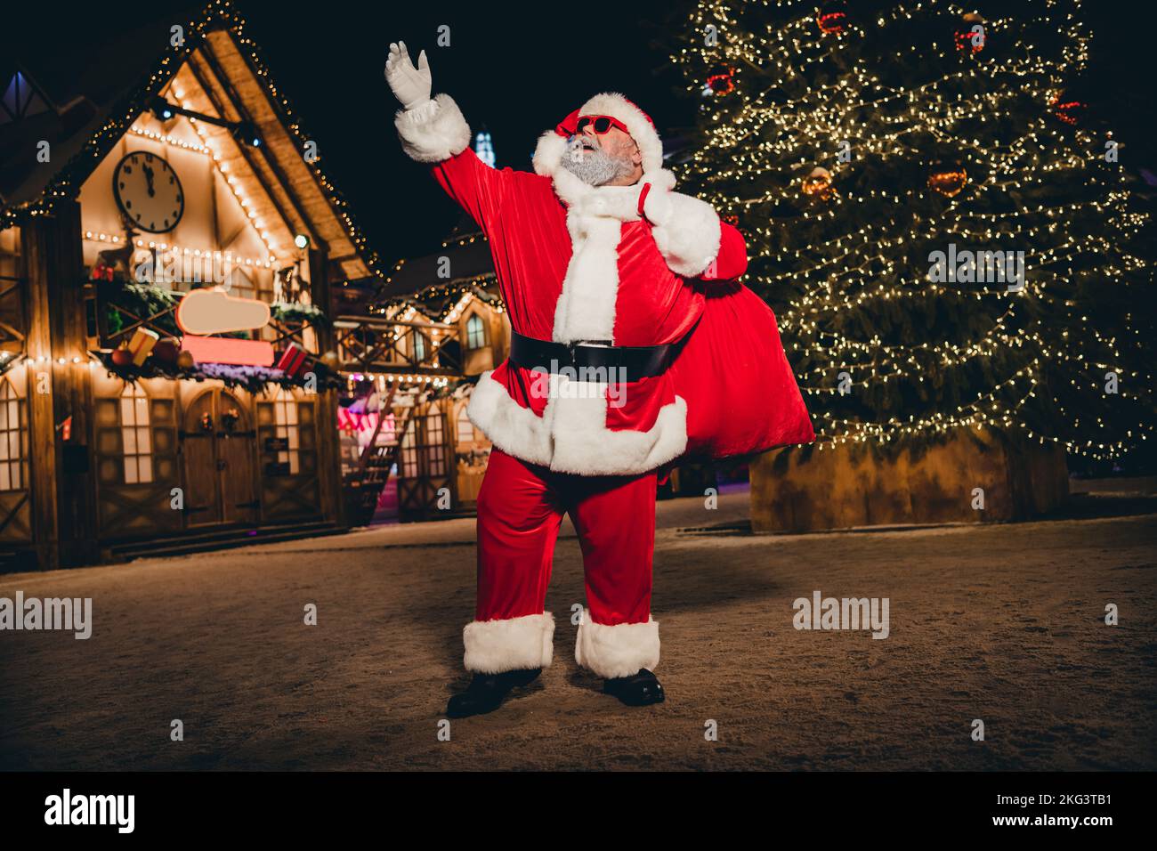 Full length portrait of positive grandfather santa carry big presents ...