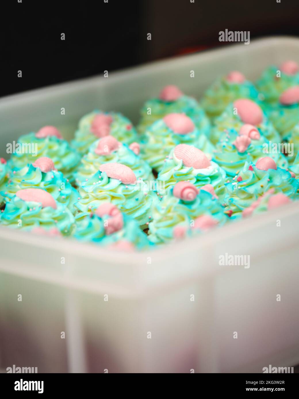 pastry chef preparing bunch of green turquoise sea theme sprinkled frosted cupcakes Stock Photo ...