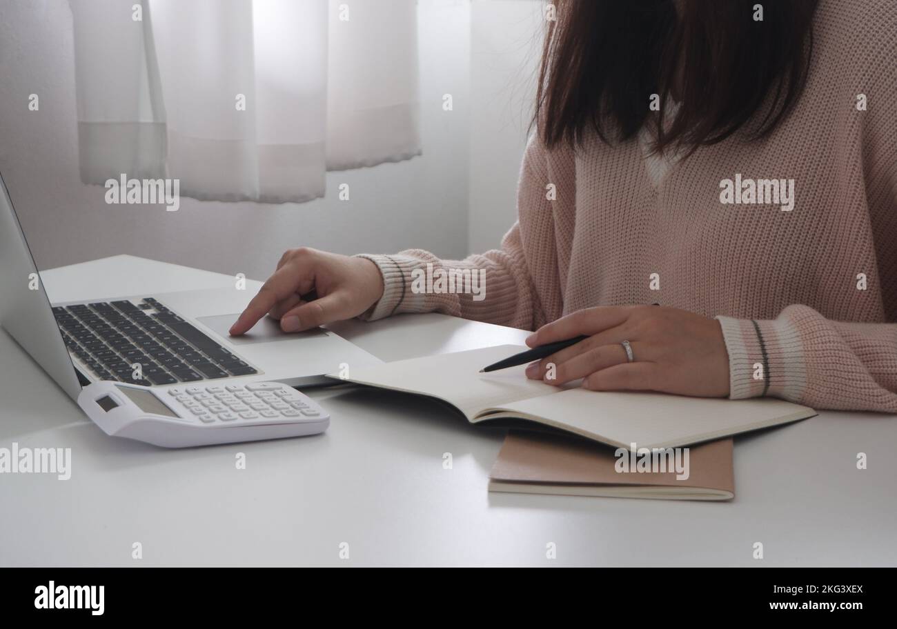 Female remotely working, studying online using laptop computer ...