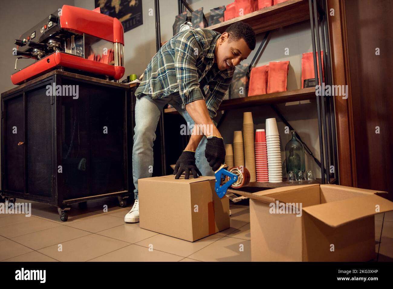 Joyous cafe employee making goods ready for delivery Stock Photo - Alamy